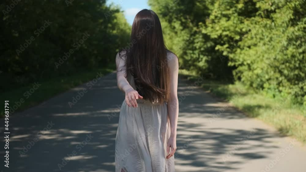 scary ghost woman in an old dress with hair covering her face, shows ...
