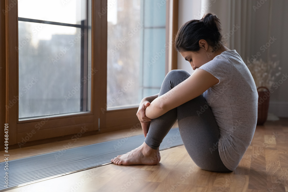 Sad young Indian woman sit look in distance window feel depressed ...