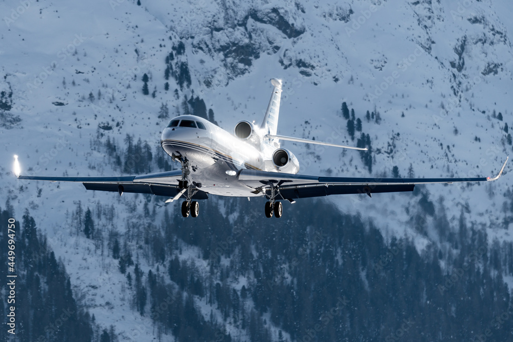 Luxury private jet approaching the engadin valley in the Swiss alps ...