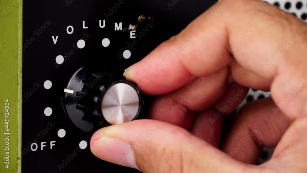 Hand adjusting volume control.Use hand to adjust the volume at the ...