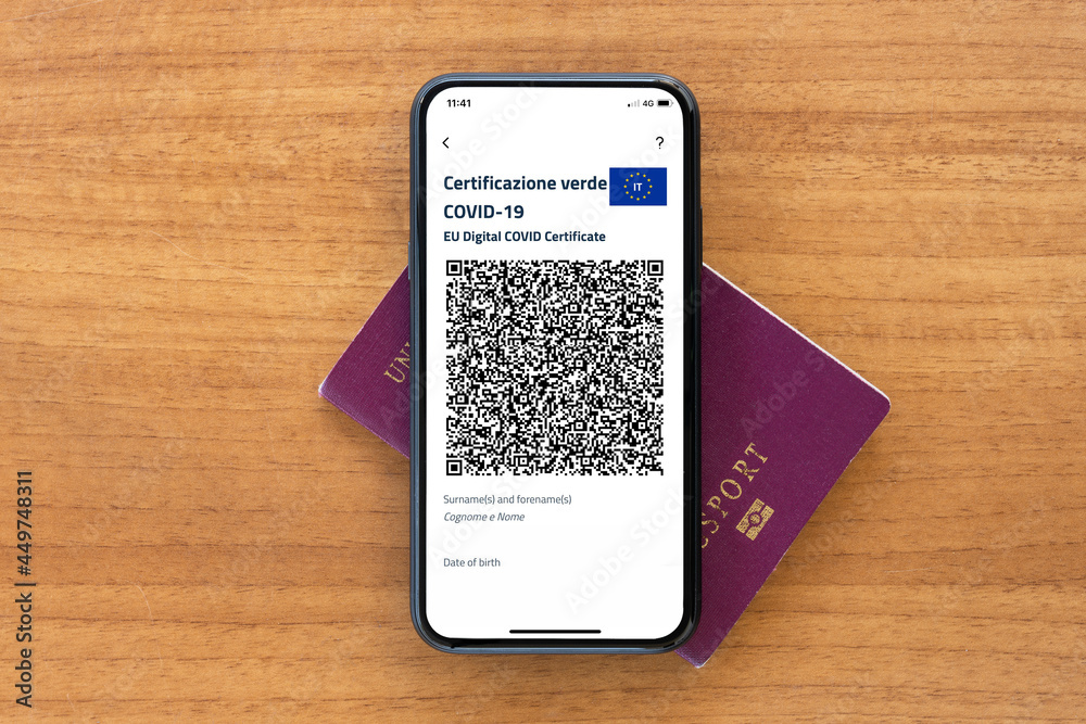 Flat lay, top view of a passport and a smartphone with the Green Pass ...