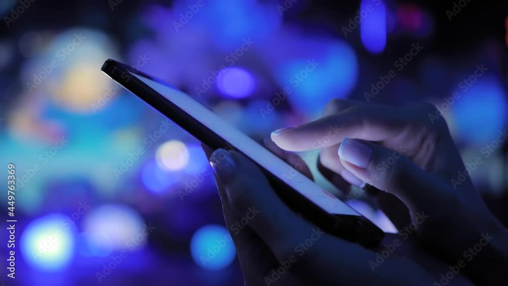 Close up side view: woman hands using smartphone device at interactive ...