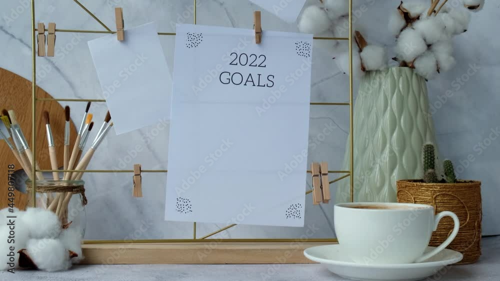 2022 GOALS Cards and posters mock ups on grid board. Woman creating ...