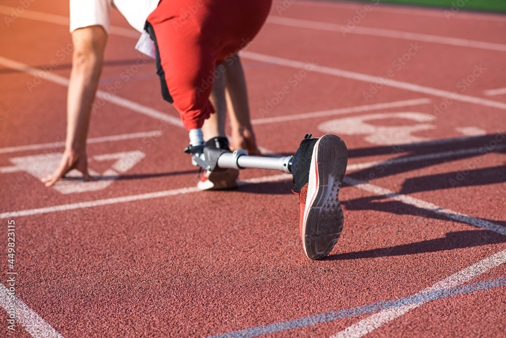 Caucasian male athlete with a prosthetic leg standing at the start on ...
