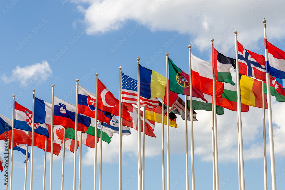 Flags of the world waving against the background of a cloudy sky. Flags ...