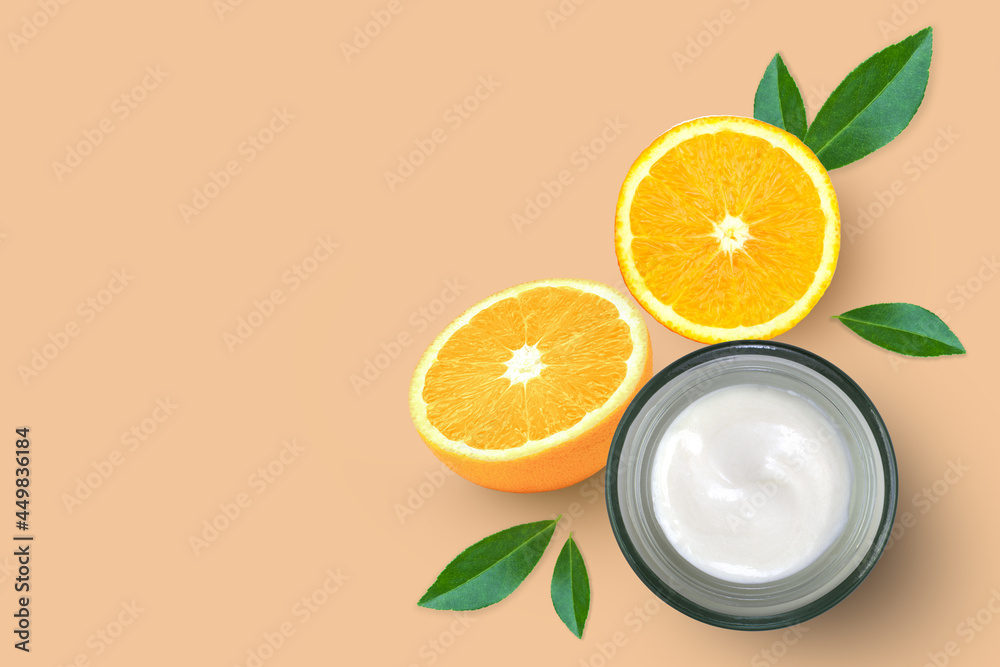 Orange skin care moisturizing cream in glass jar with fresh orange ...