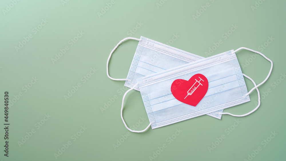 double medical masks ,red heart paper shape with white syringe icon ...