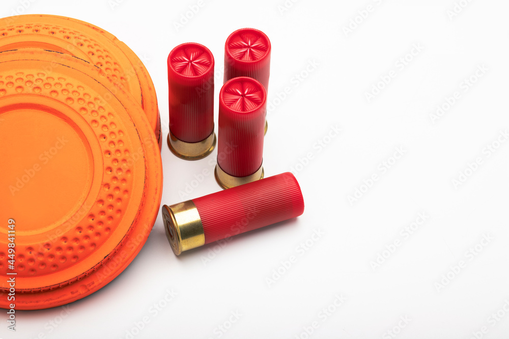 Clay shooting target and shotgun bullets on white background ,Clay ...