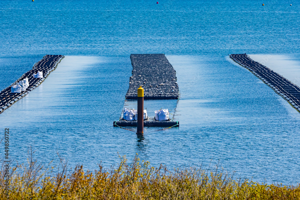 Lake Grevelingenmeer with black buoys floating in blue water, possibly ...