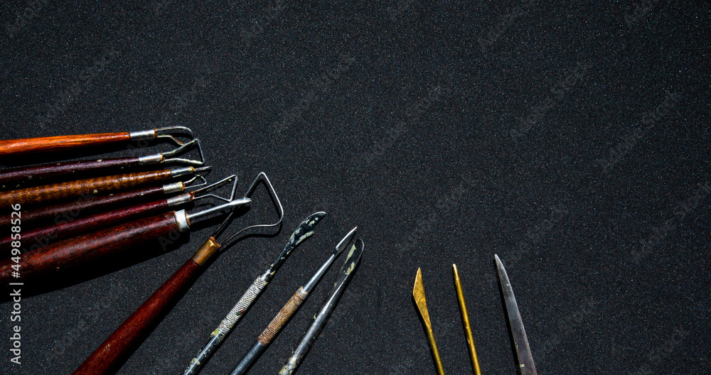 Sculpture tools on black background with copy space. Artist's toolkit ...