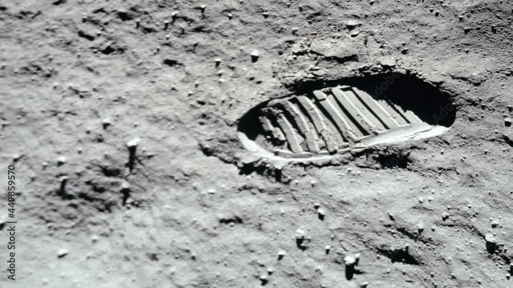 Lunar astronaut walking on the moon's surface and leaves a footprint in ...