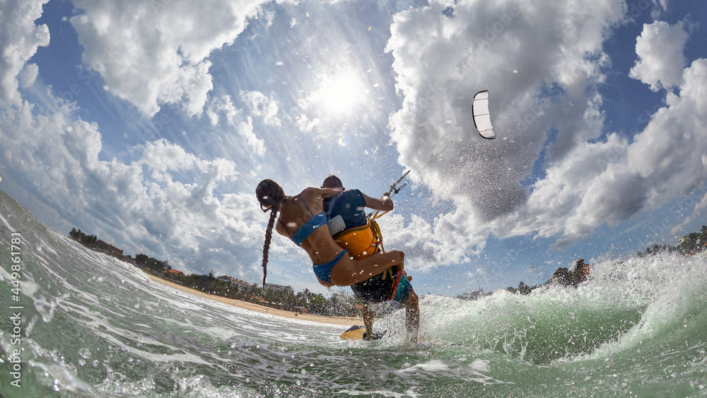 Lovely couple up on one kite board. Woman Riding On Kite surfer's Back ...