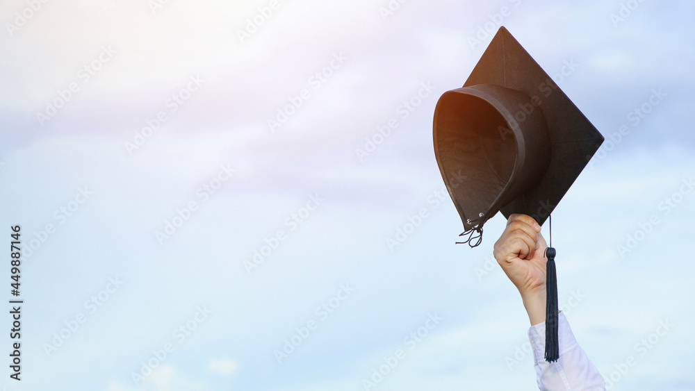 Graduates are celebrating graduation put a hand up, a certificate, and ...