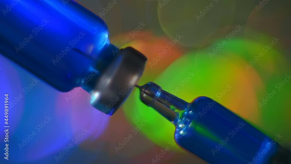 The needle of a glass modern syringe for vaccine injection takes ...