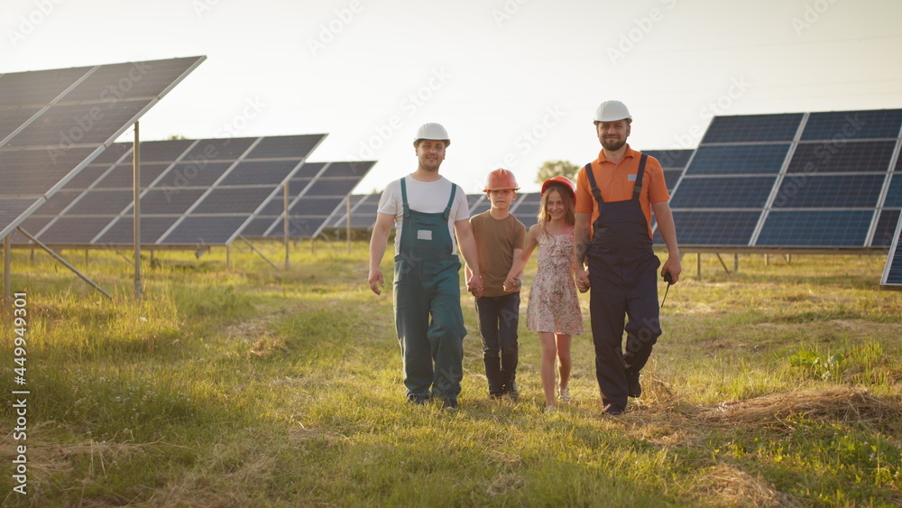 Two parents brought their children to work. Two employees of a solar ...
