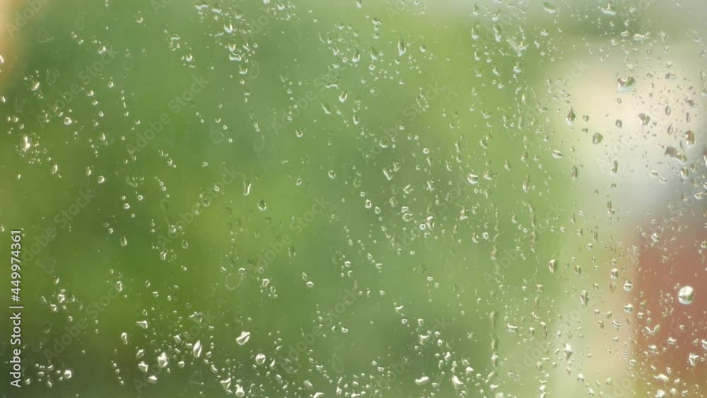 Bad weather on a summer day. Heavy rain outside the window, drops of ...