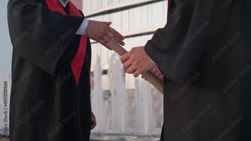 Graduation ceremony, senior lecturer presents a diploma to a university ...