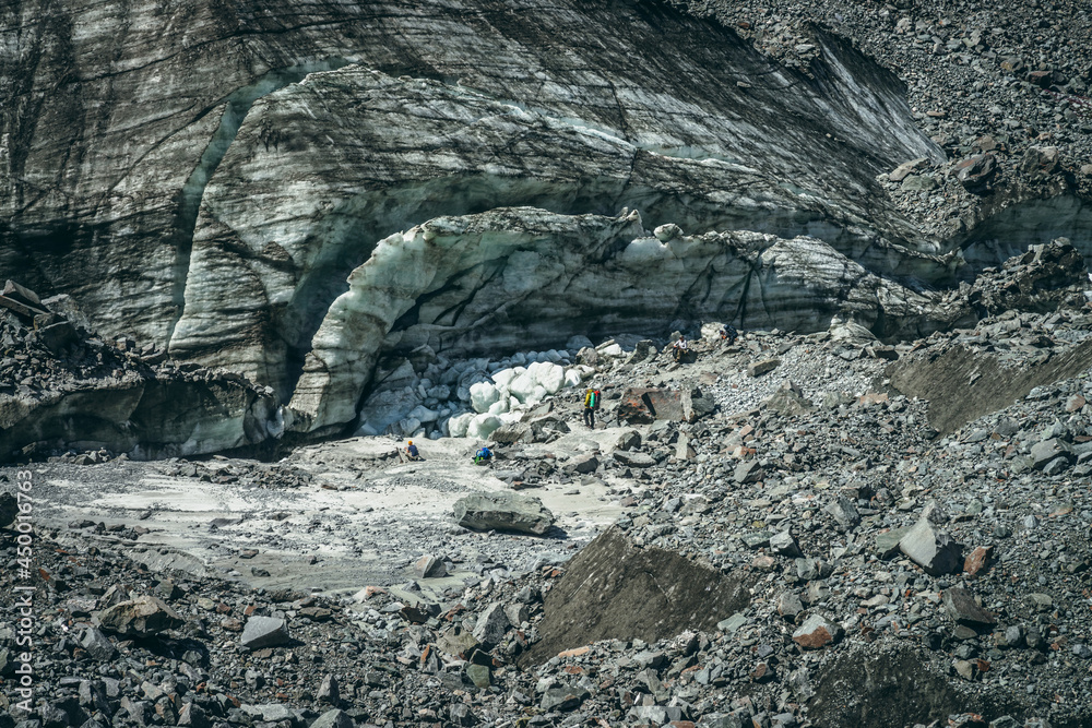 Scenic mountain landscape with hikers among ice blocks of cracked ...