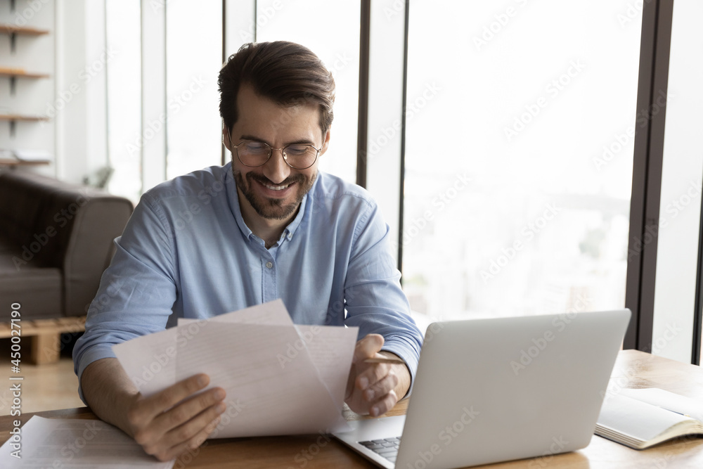 Happy business professional in glasses reviewing official legal ...