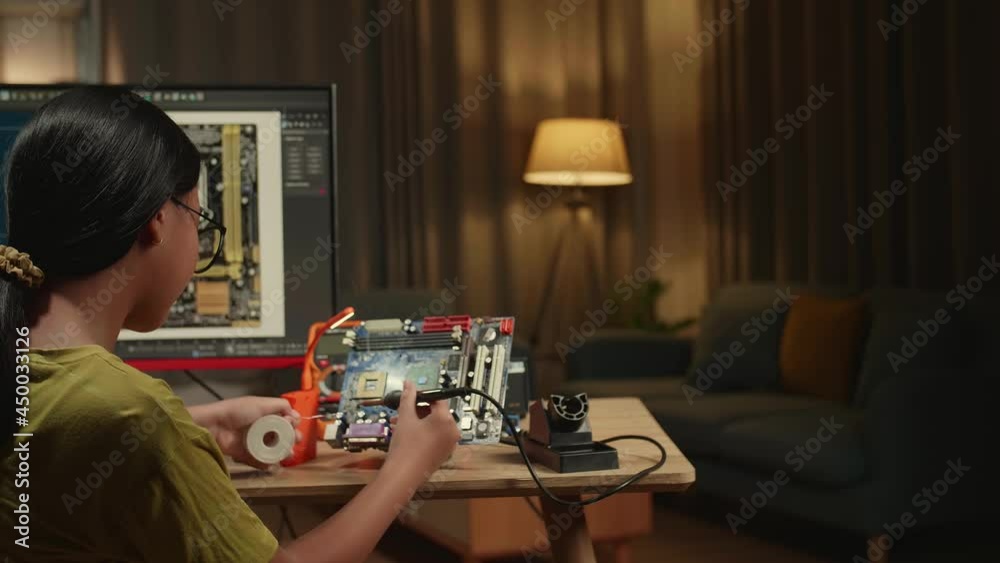 It Girl Is Soldering Electronic Circuit And Works With Computer In Home ...