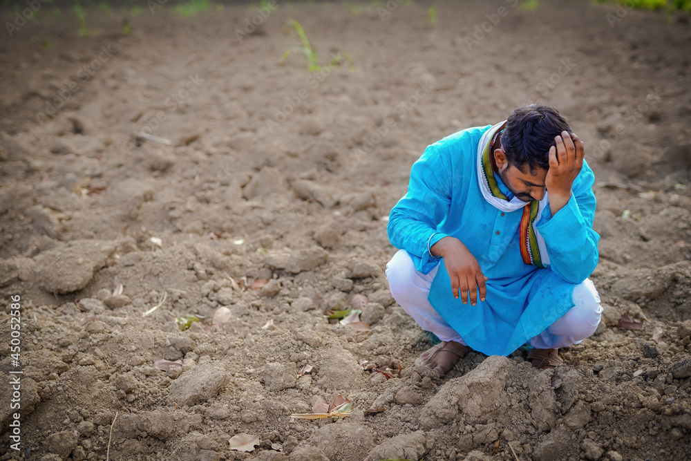 Indian poor farmer troubled by soil defect, sad farmer in the field ...