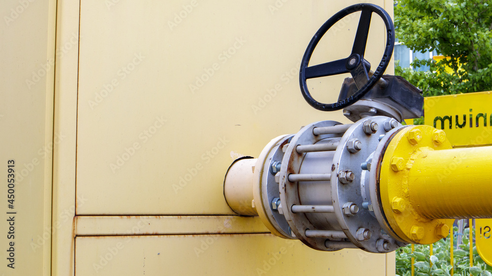 Yellow gas pipe with a tap. Oil pipeline fittings in the oil and gas ...