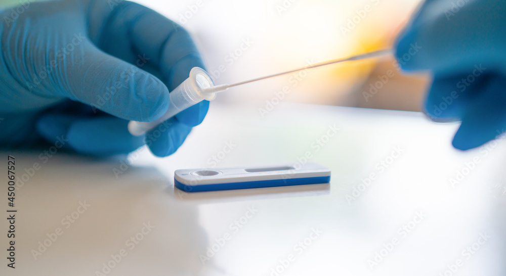 Man using a rapid antigen test kit. Rapid antigen testing is a ...