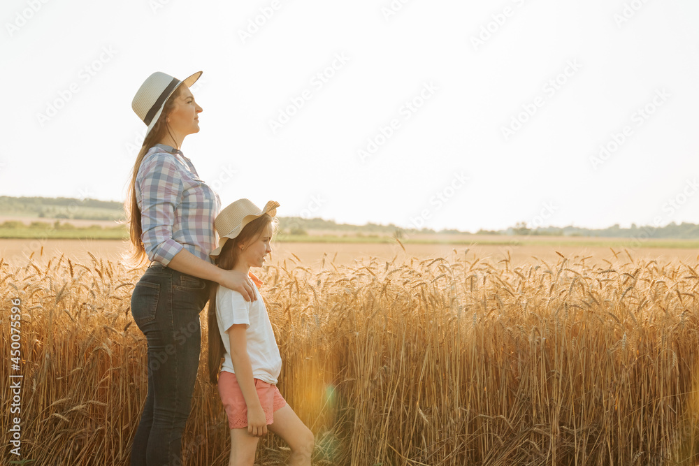side view, portrait family of farmers mother with daughter in hats in ...