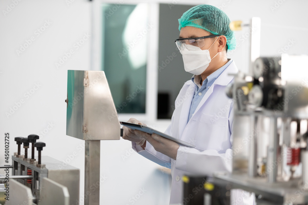 factory worker using tablet computer for finding how to use machine ...