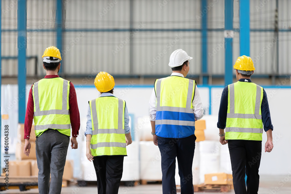back view factory workers walking in warehouse for start a work Stock ...
