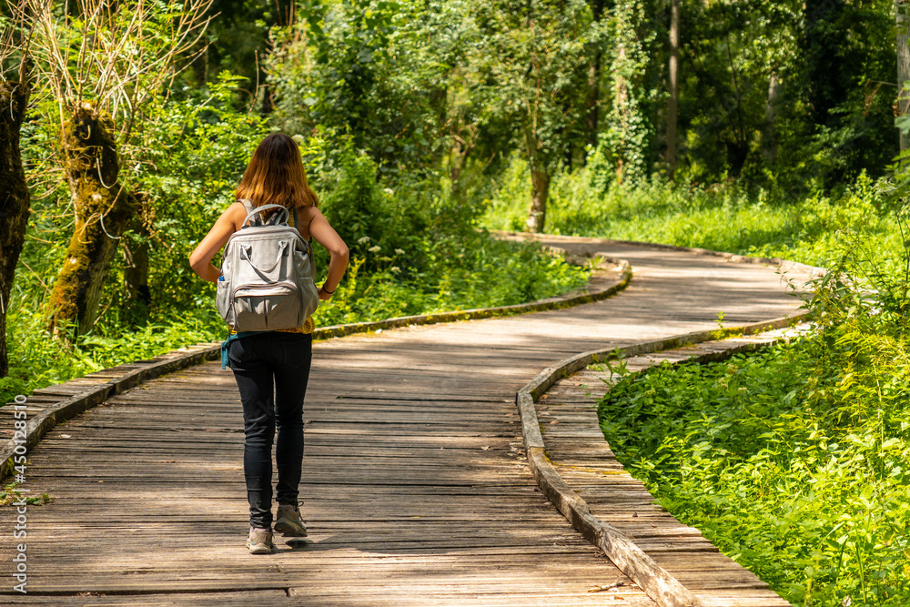 A young woman walking on the trek on the trail between La Garette and ...