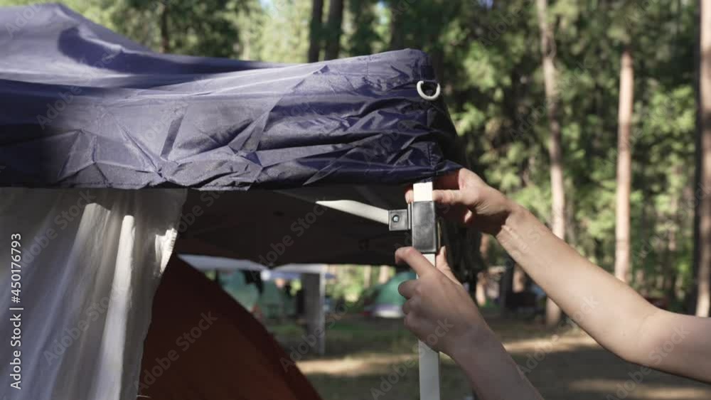 This video shows anonymous camper hands assembling a pop up tent by ...