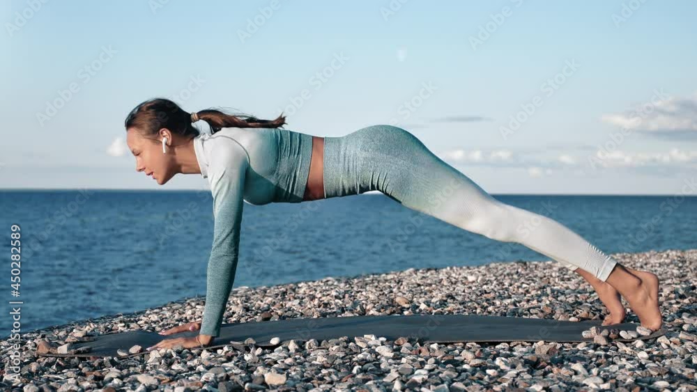 Fitness lady performing push ups at pebble beach healthy lifestyle ...