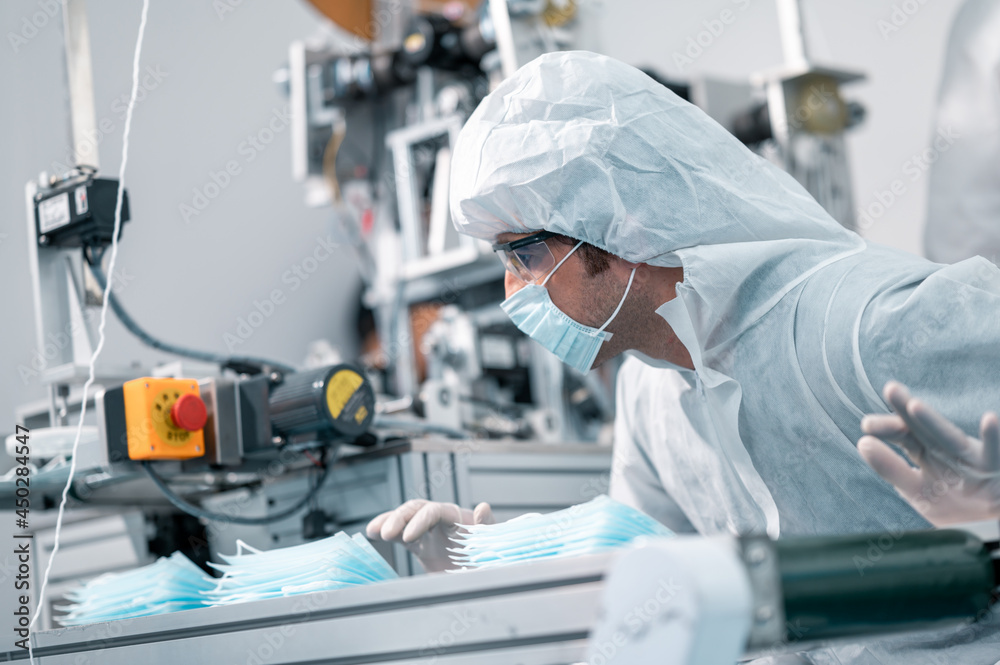 Scientists wearing uniform protection. Check the manufacturing process ...