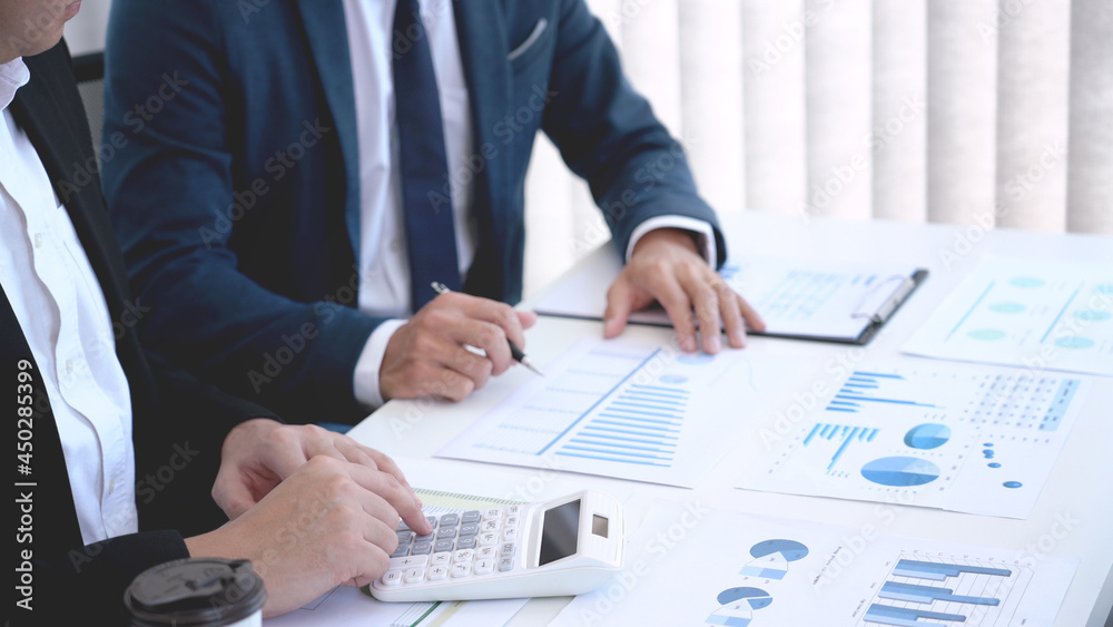 Business concept a couple of business partners calculating annual ...