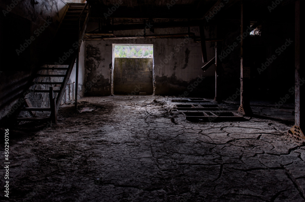 Old factory interior backdrop. Dark room with cracked dirt on the floor ...