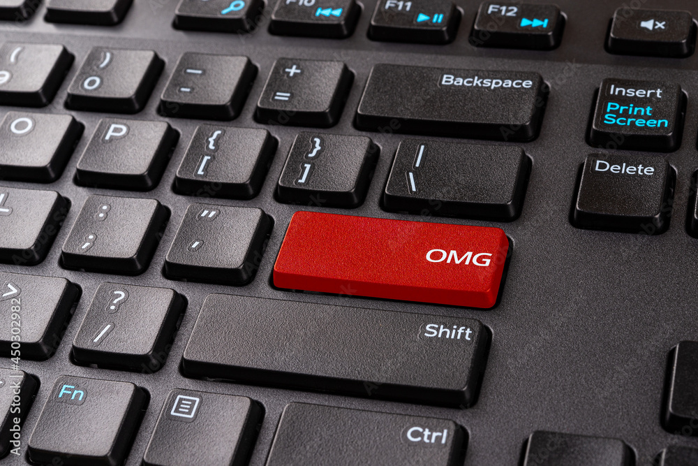 OMG red key on a black pc keyboard. Desktop keyboard with Omg gamer ...