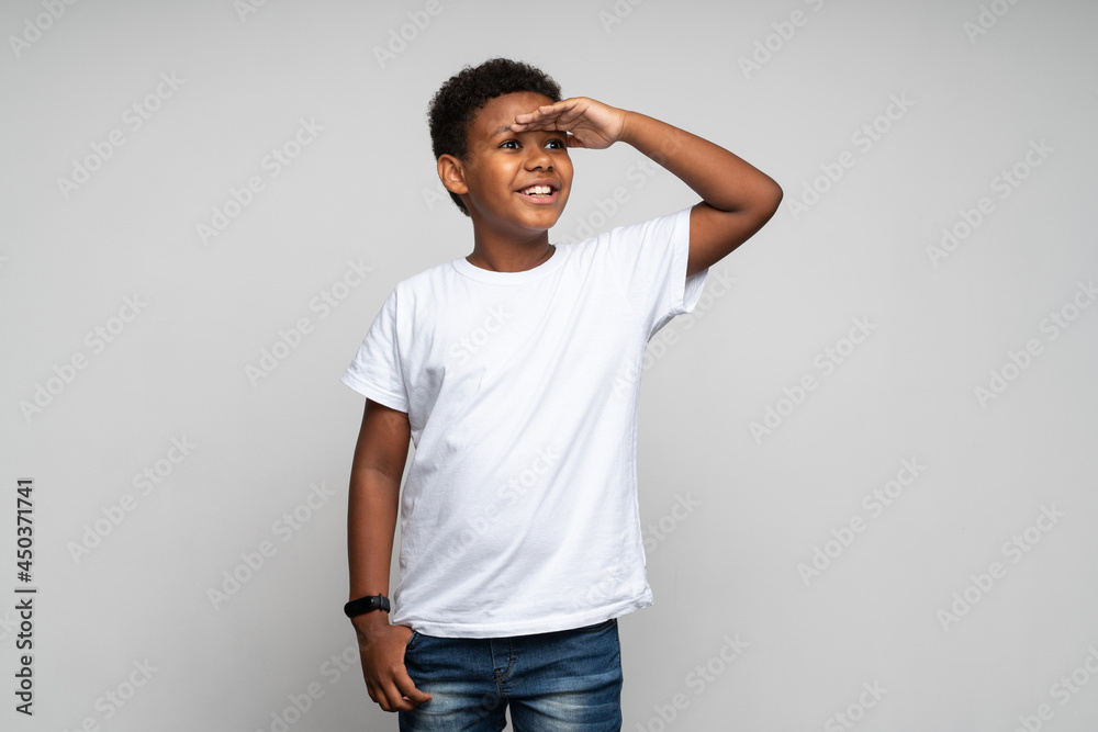 Portrait of astonished little boy with curls holding hand over eyes and ...
