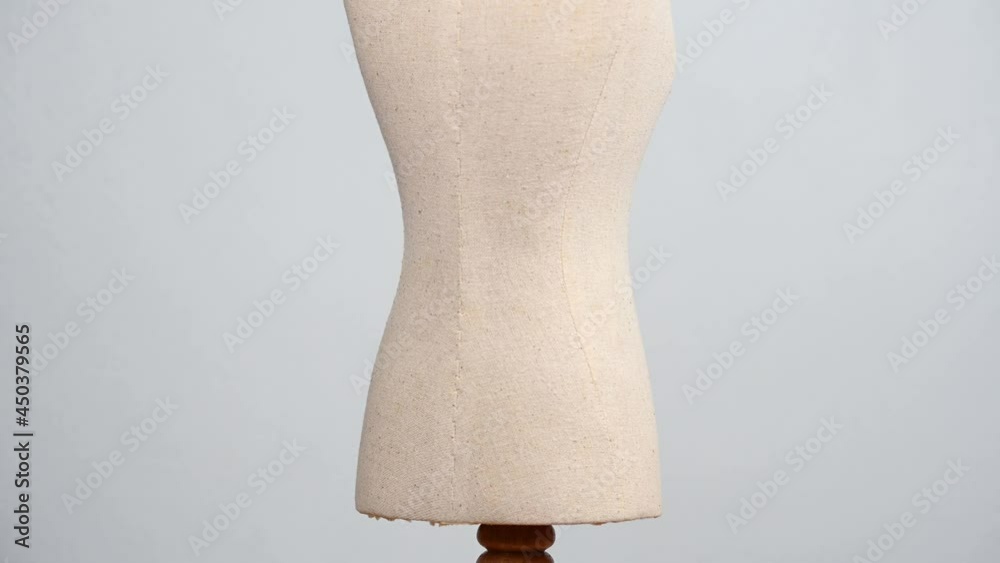 close up of a fabric and wood vintage dummy dress mannequin standing ...
