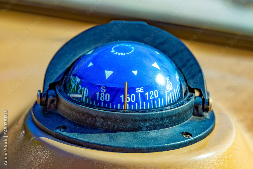 Gyrocompass on the wooden dashboard of an expensive yacht close-up ...