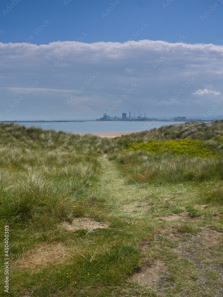 The skeletal hulk of Redcar Steelworks in silhouette, seen between ...