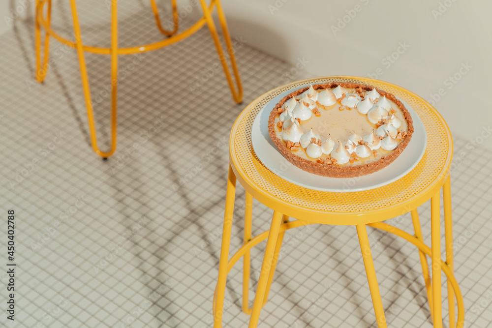 Icebox pie on a yellow stool inside of a diner Stock Photo | Adobe Stock