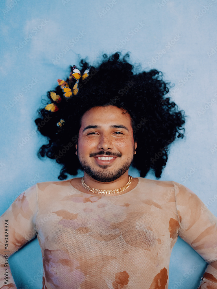 Man with butterflies in his hair Stock Photo | Adobe Stock