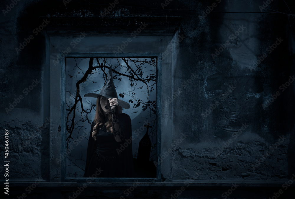 Scary halloween witch standing in old damaged window with wall over ...