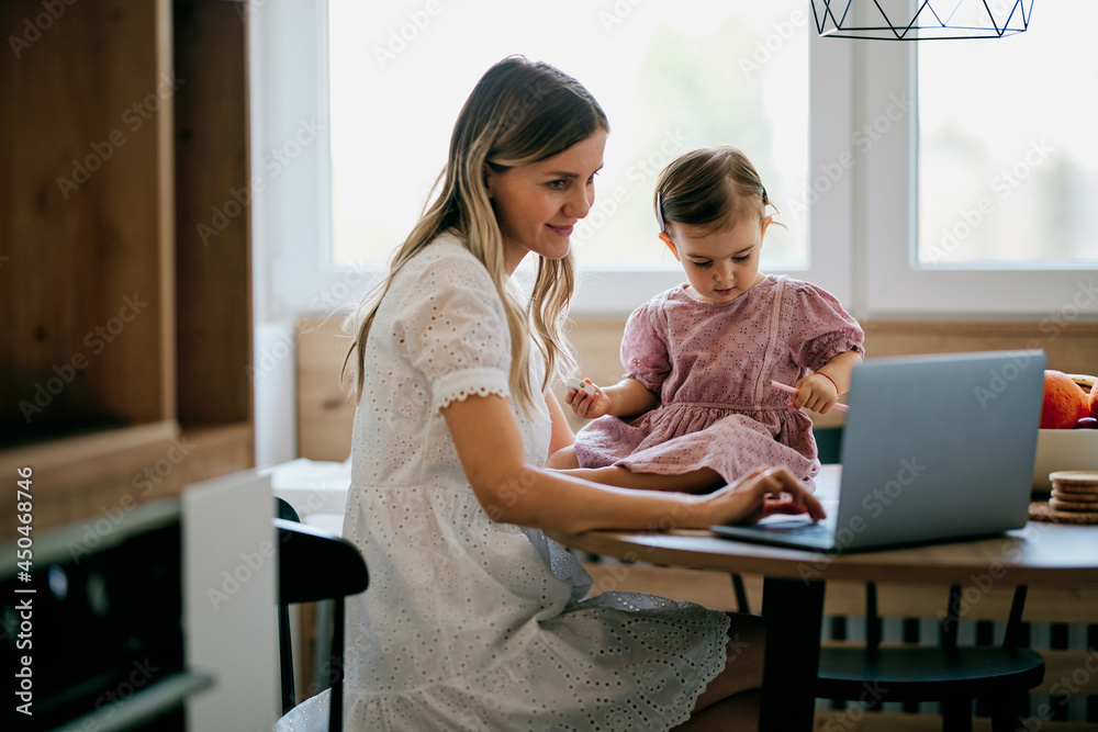 Stay at mother home sitting in kitchen and getting work done while her ...
