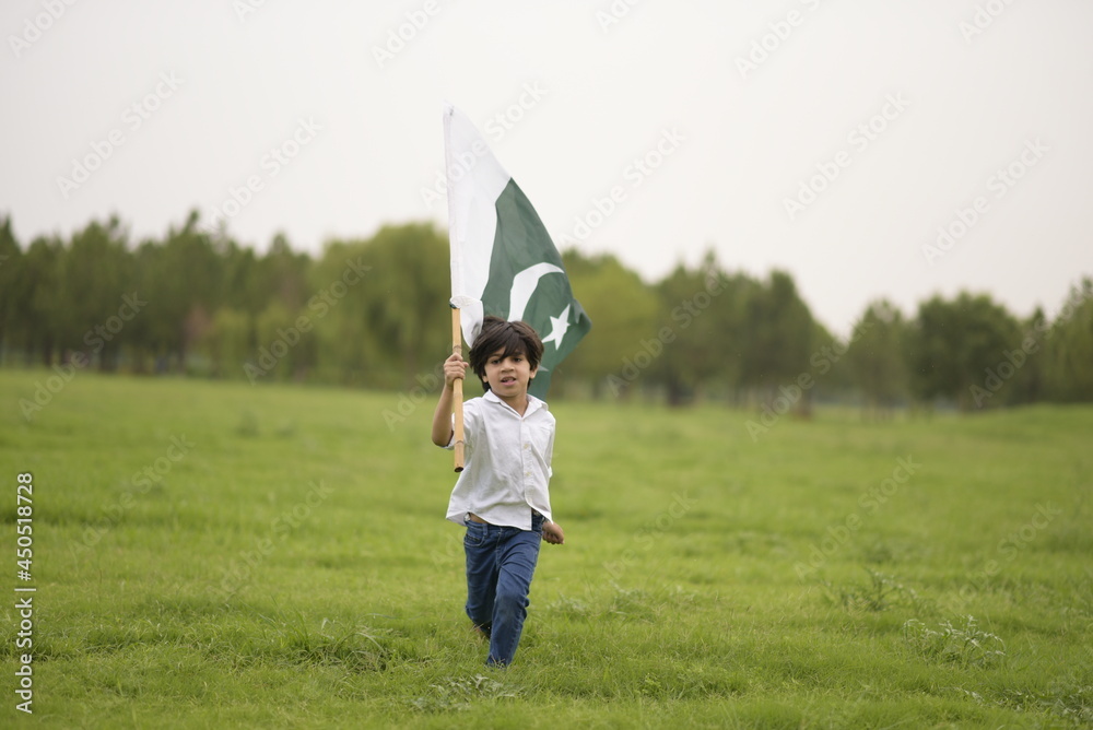 cheerful active little boy celebrating 14th of August, Pakistan ...