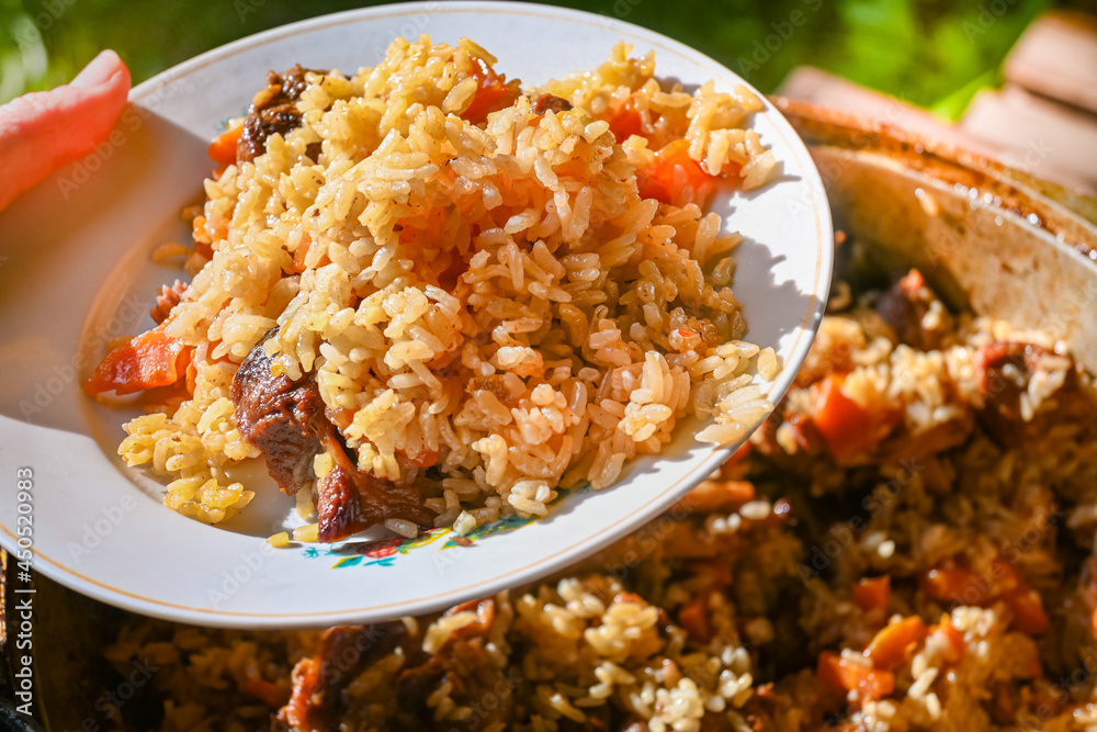 Traditional oriental pilaf in a cauldron Stock Photo | Adobe Stock