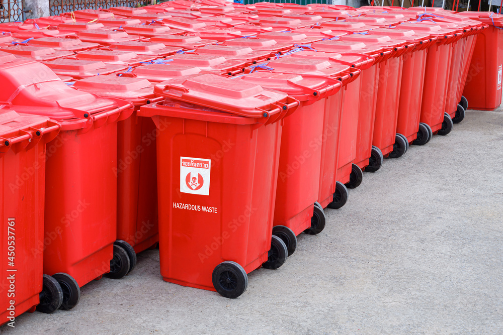 Rows of red hazardous waste bins are neatly packed with rubbish from ...