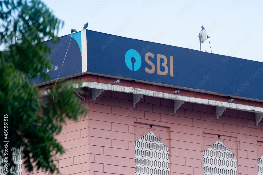 Blue state bank of India SBI board hoarding on top of pink building ...