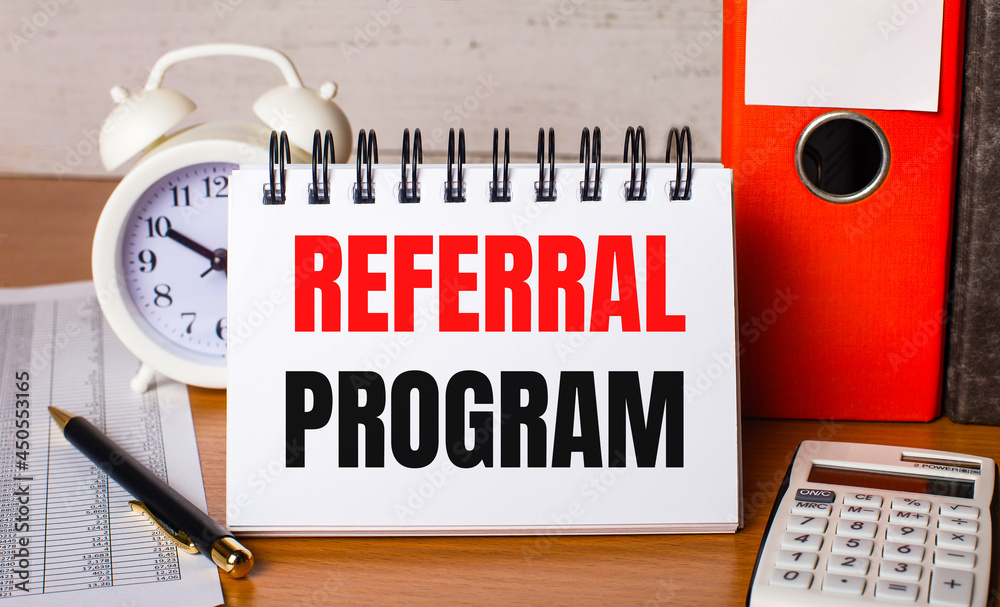 On the table are reports, a white alarm clock, a calculator, folders ...